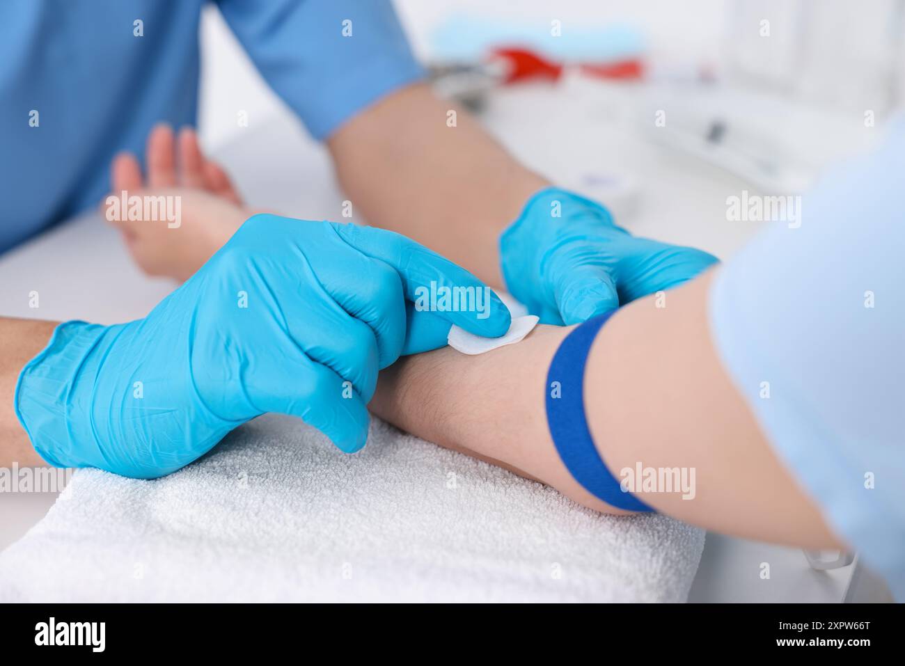 Nurse inserting IV into arm of patient in hospital, closeup Stock Photo ...