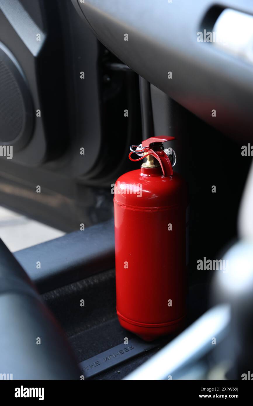Red fire extinguisher in automobile. Car safety equipment Stock Photo ...