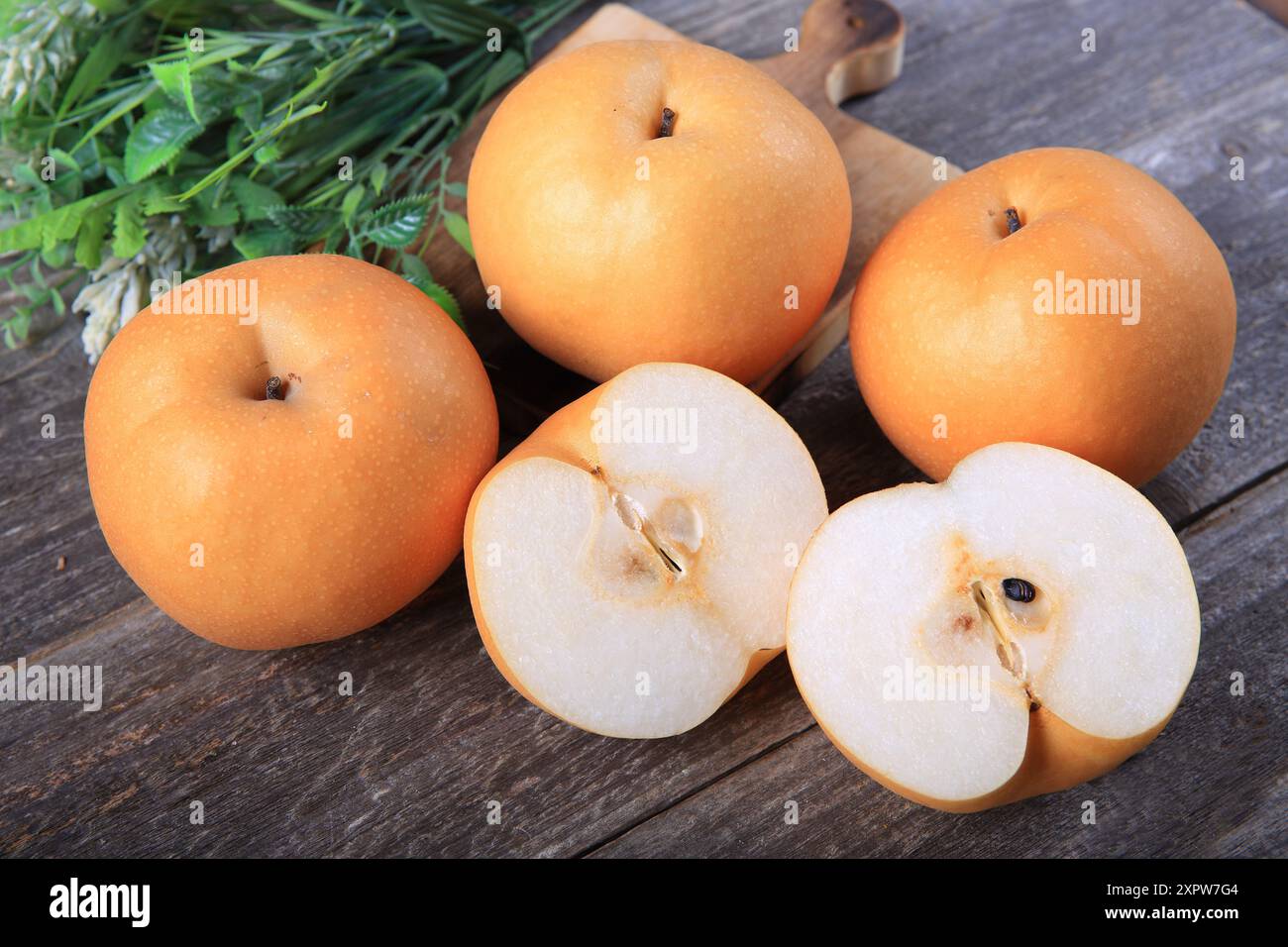 Asian pear on a wooden background Stock Photo - Alamy