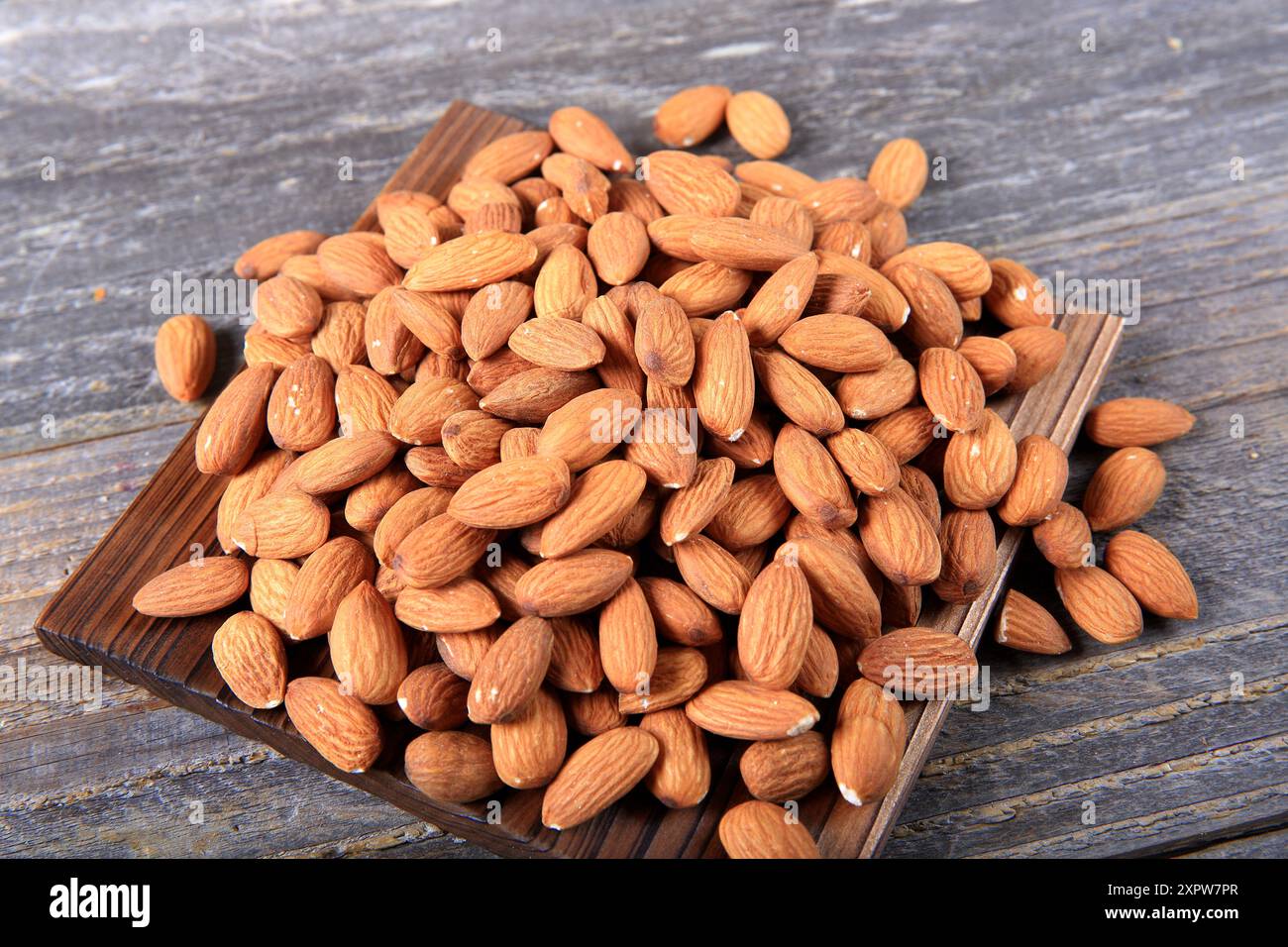Group of almonds on wood background Stock Photo - Alamy