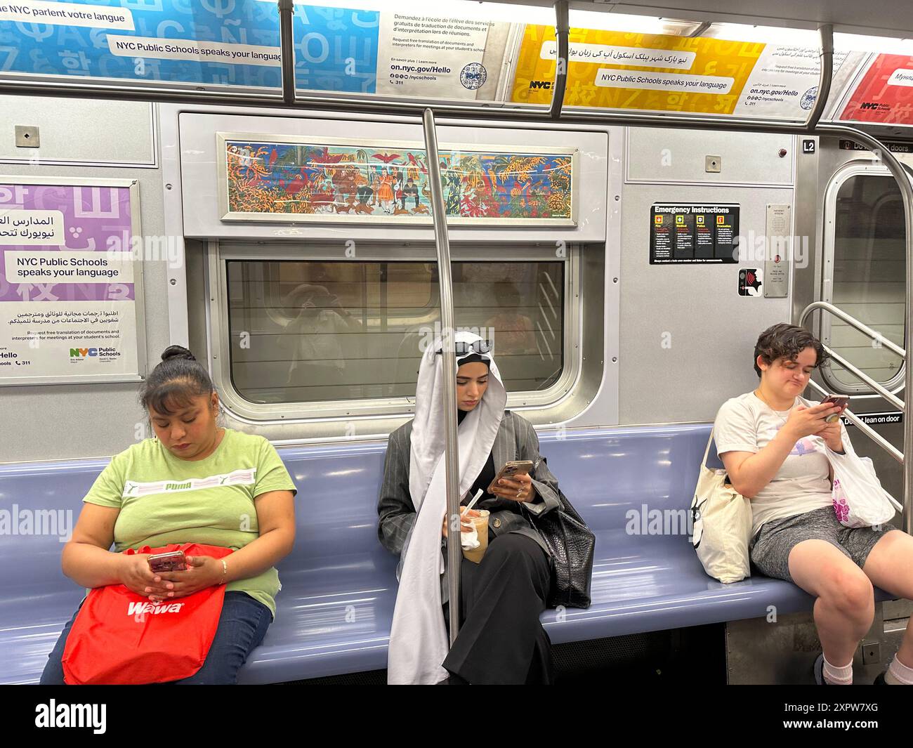 New York subway commuters on F train to Manhattan. Posters advertising ...