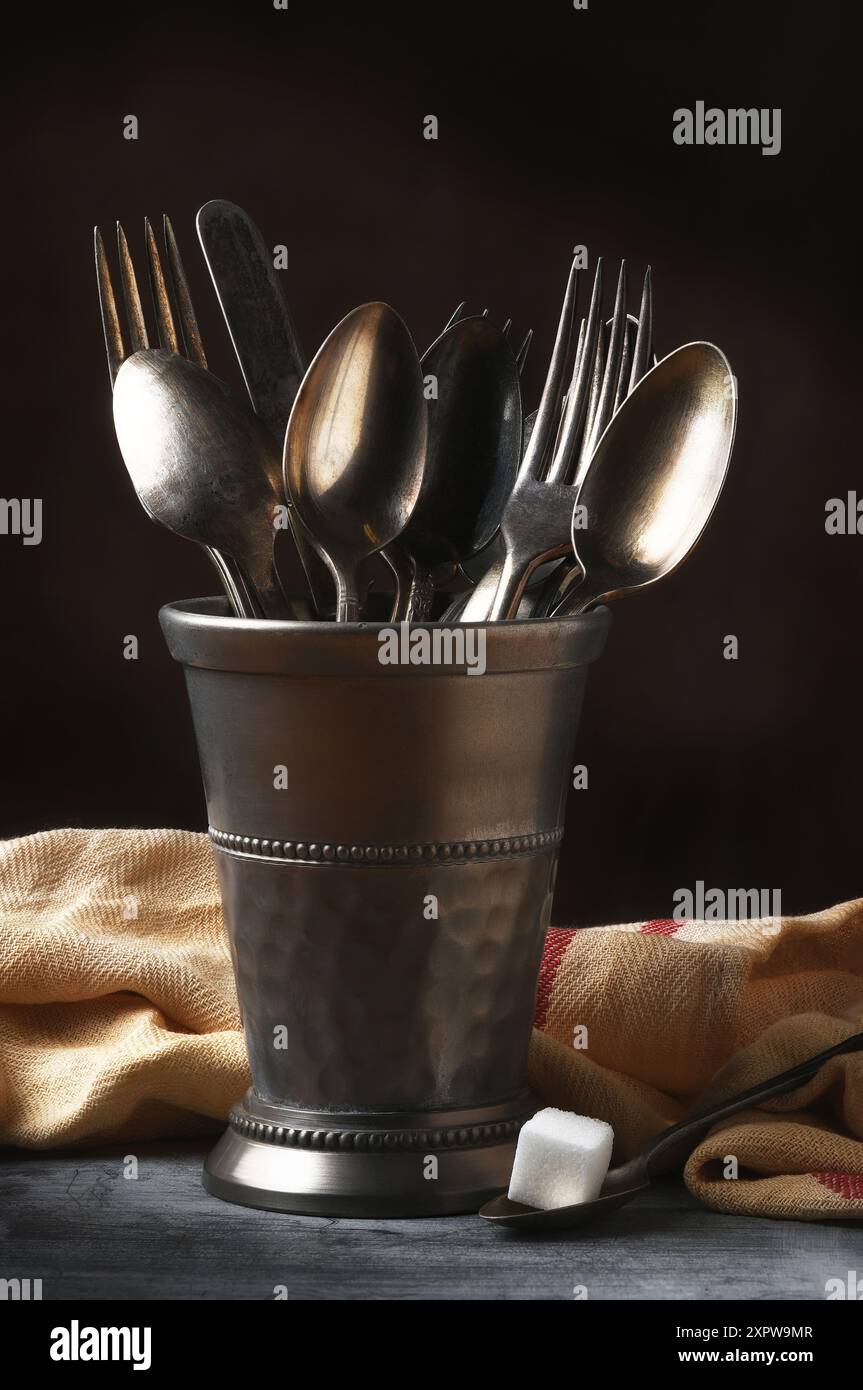 Flatware in pewter cup still life Stock Photo - Alamy