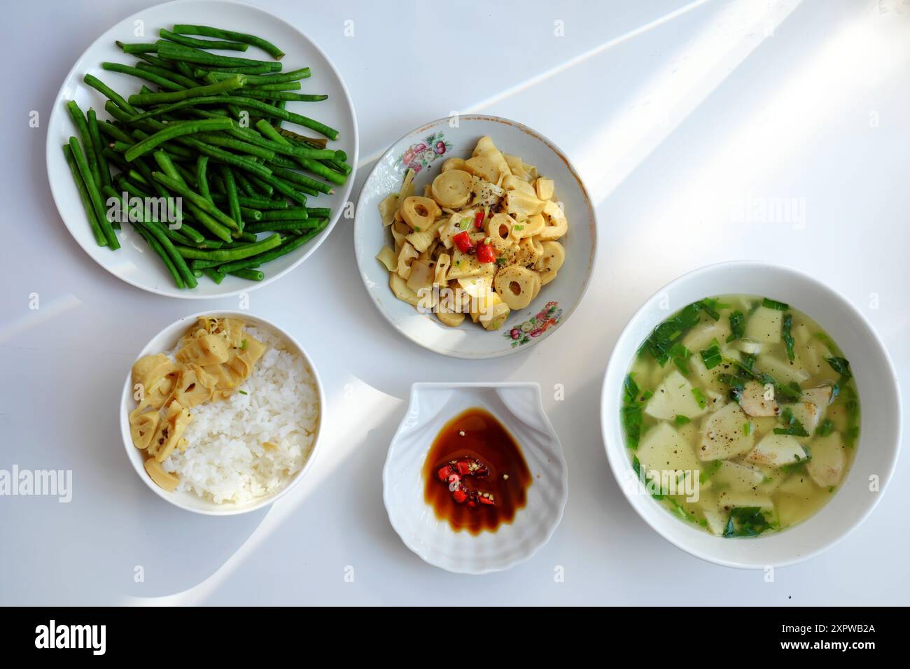 Vietnamese meal with steamed rice, tofu and vegetable soup, stir-fried ...