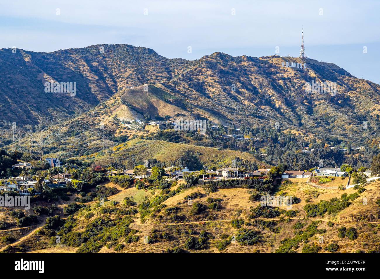 The Hollywood sign, seen from Mulholland Drive, with houses on a ridge ...