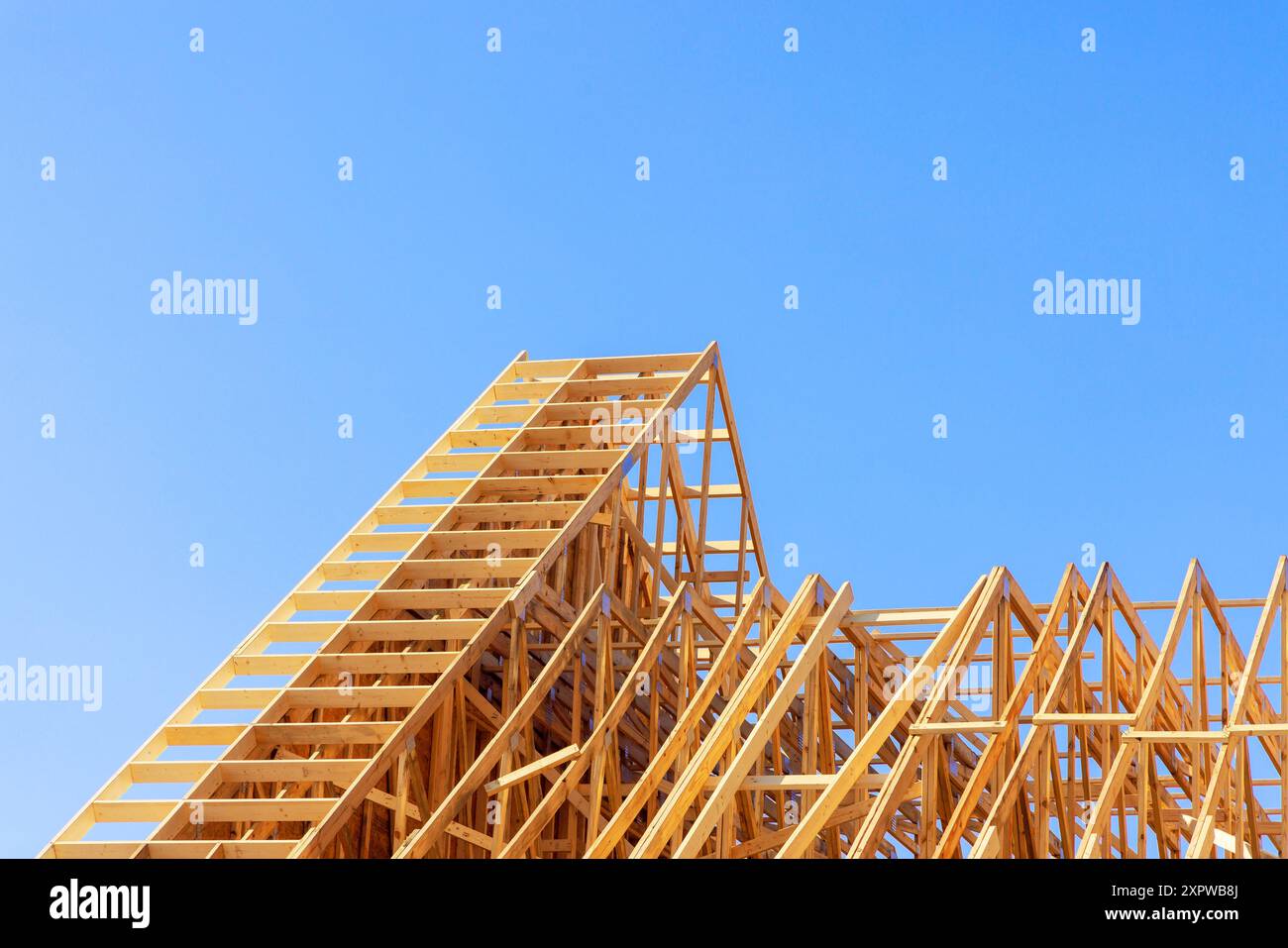 Installation beams of wooden roof trusses to house under construction ...