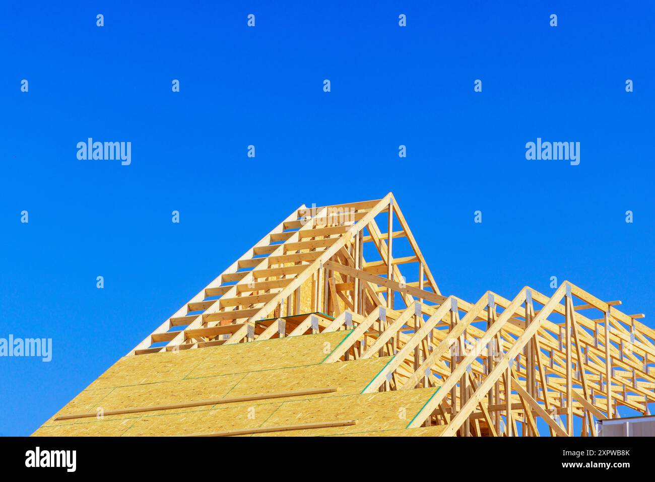 Frame is being installed under construction roof of house in install ...