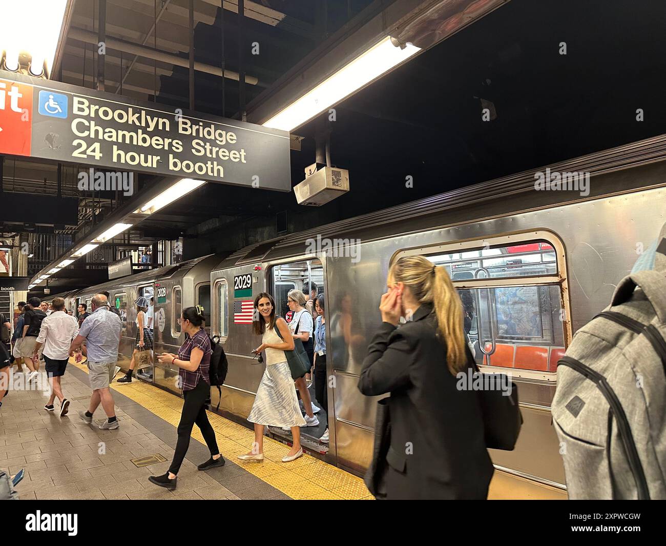 NYC commuters exiting subway train at the Brooklyn Bridge subway ...