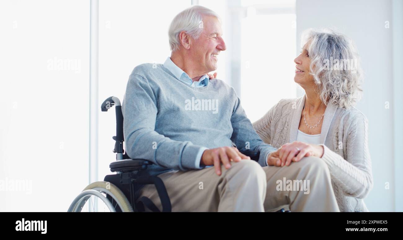 Couple, smile and senior patient with wheelchair, holding hands and ...