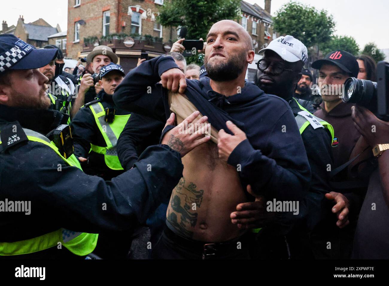 Police remove a man wearing a Cross of St George Flag during an Anti ...