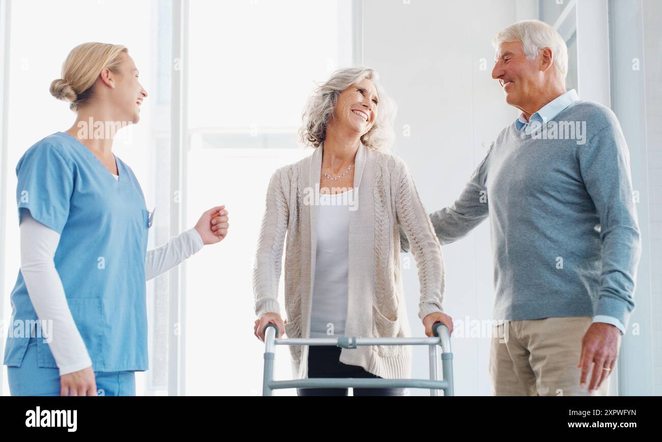 Caregiver, walking and senior patient with walker, old couple and ...