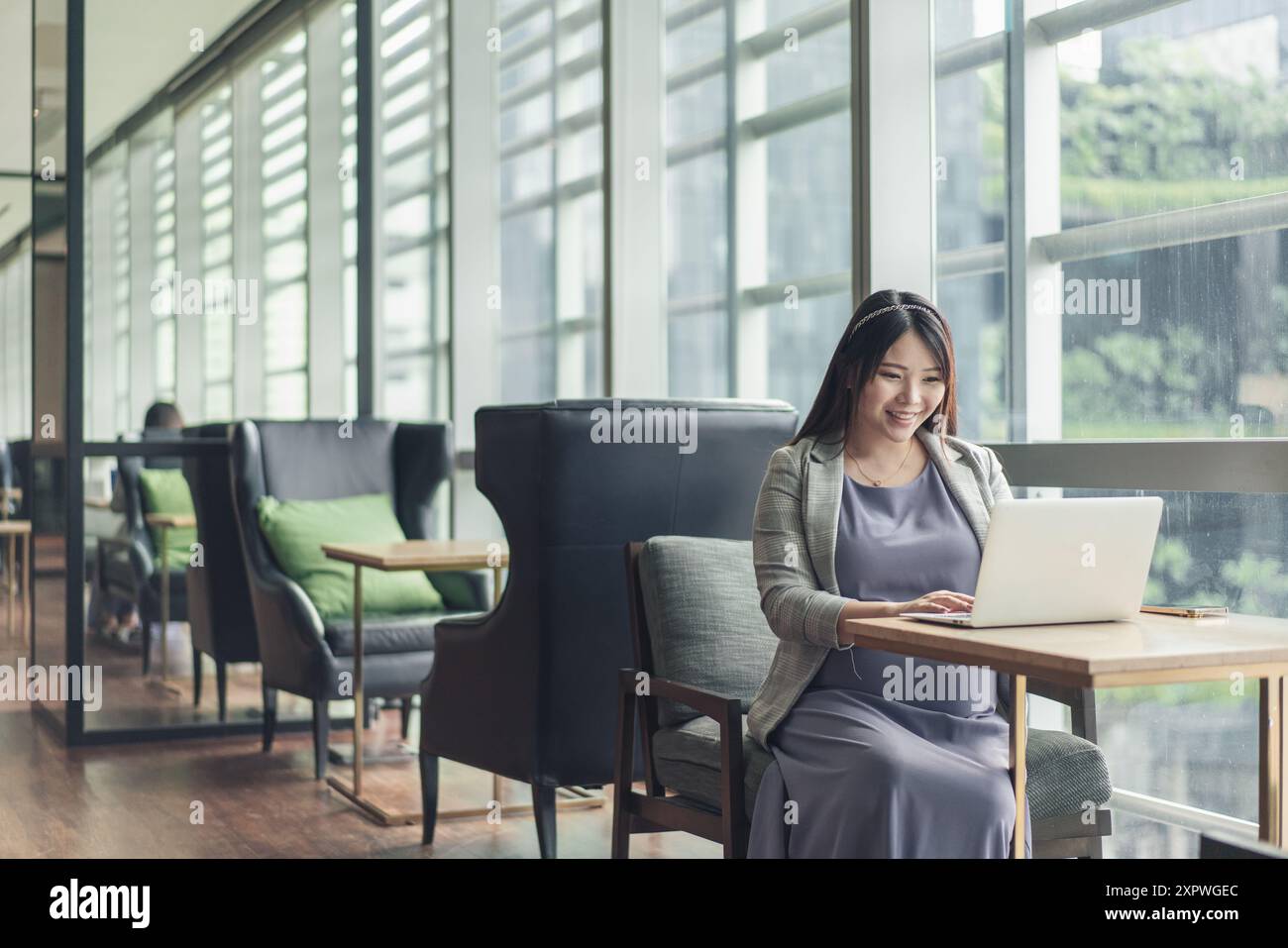 Pregnant Asian woman working remotely Stock Photo - Alamy