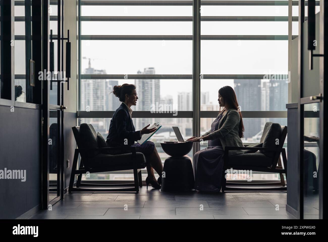 Diverse Asian business executives discussing Stock Photo - Alamy