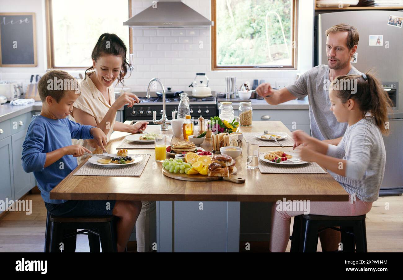 Happy family, kitchen table and eating breakfast for nutrition, food ...