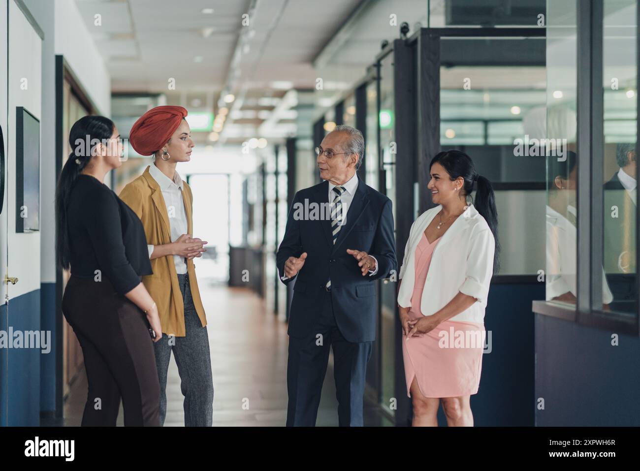 Diverse Asian team members in discussion Stock Photo - Alamy