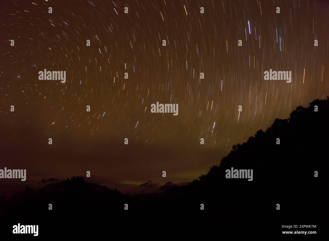 Star Trail of night sky over the mountains Stock Photo - Alamy