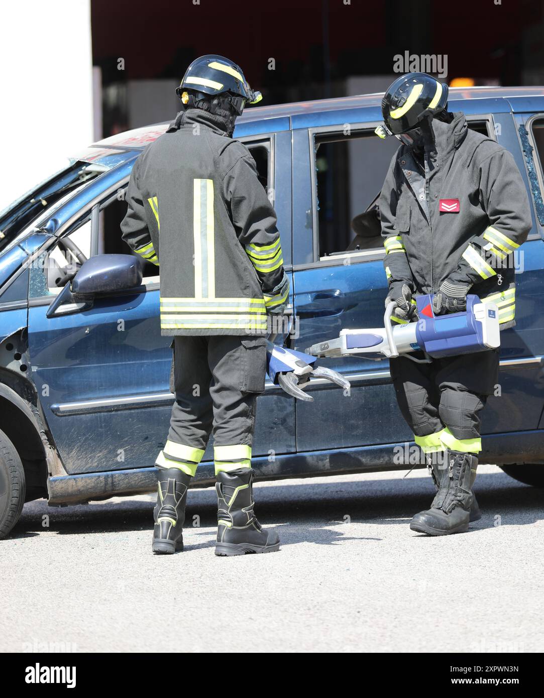 firefighters using powerful hydraulic shears and spreaders open the ...