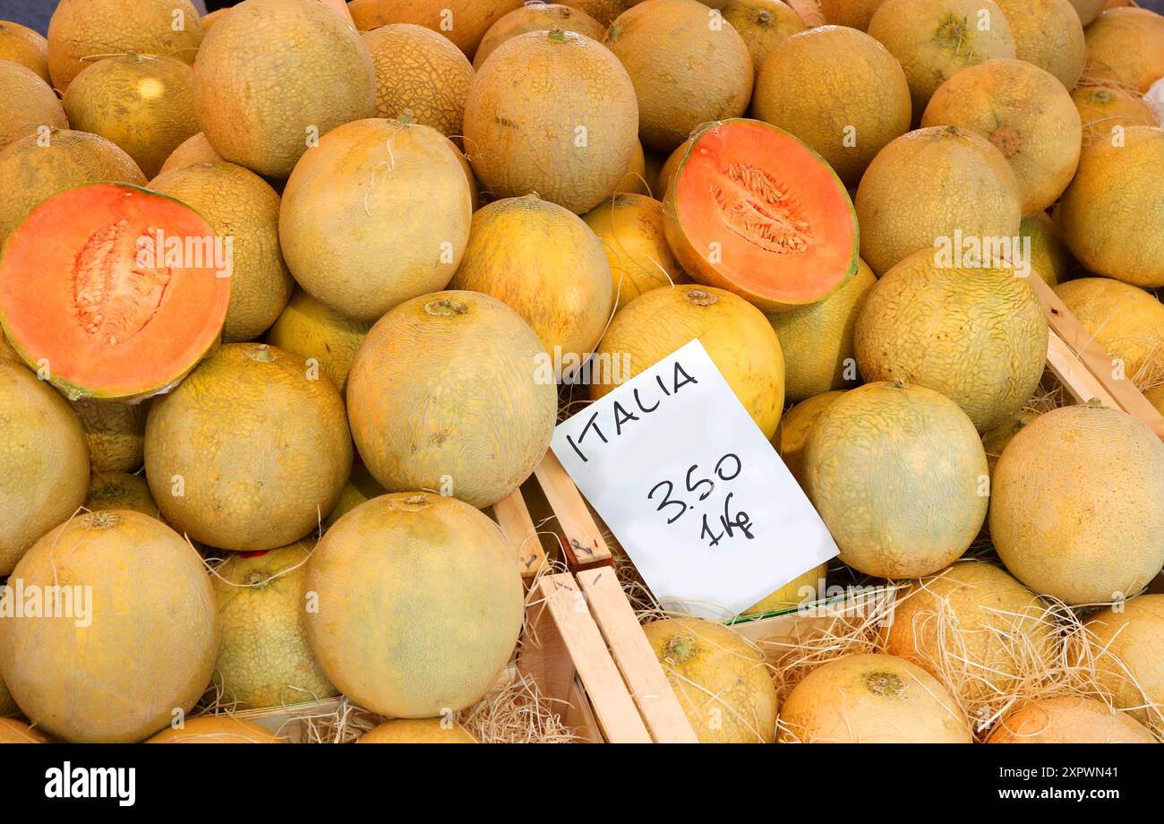 Ripe melons at a fruit vendor s stall with a price tag in Italy during ...