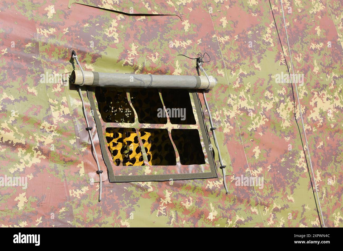 open windows of a military tent with camouflage fabric to prevent ...