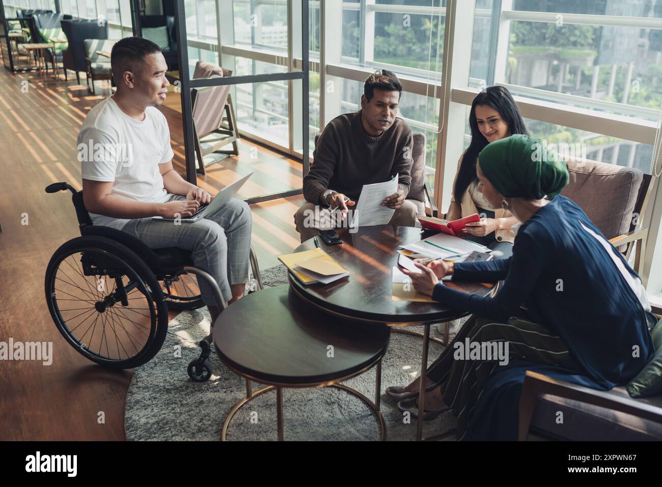 Diverse Asian business executives including a disabled man in ...