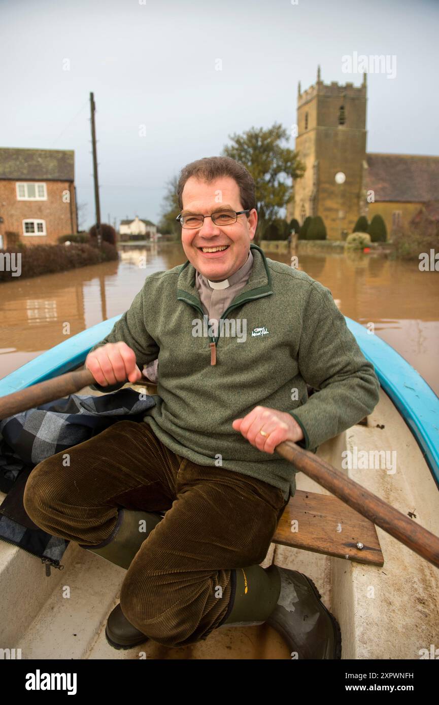 The Revd John Longuet-Higgins negotiates flood water from the River ...