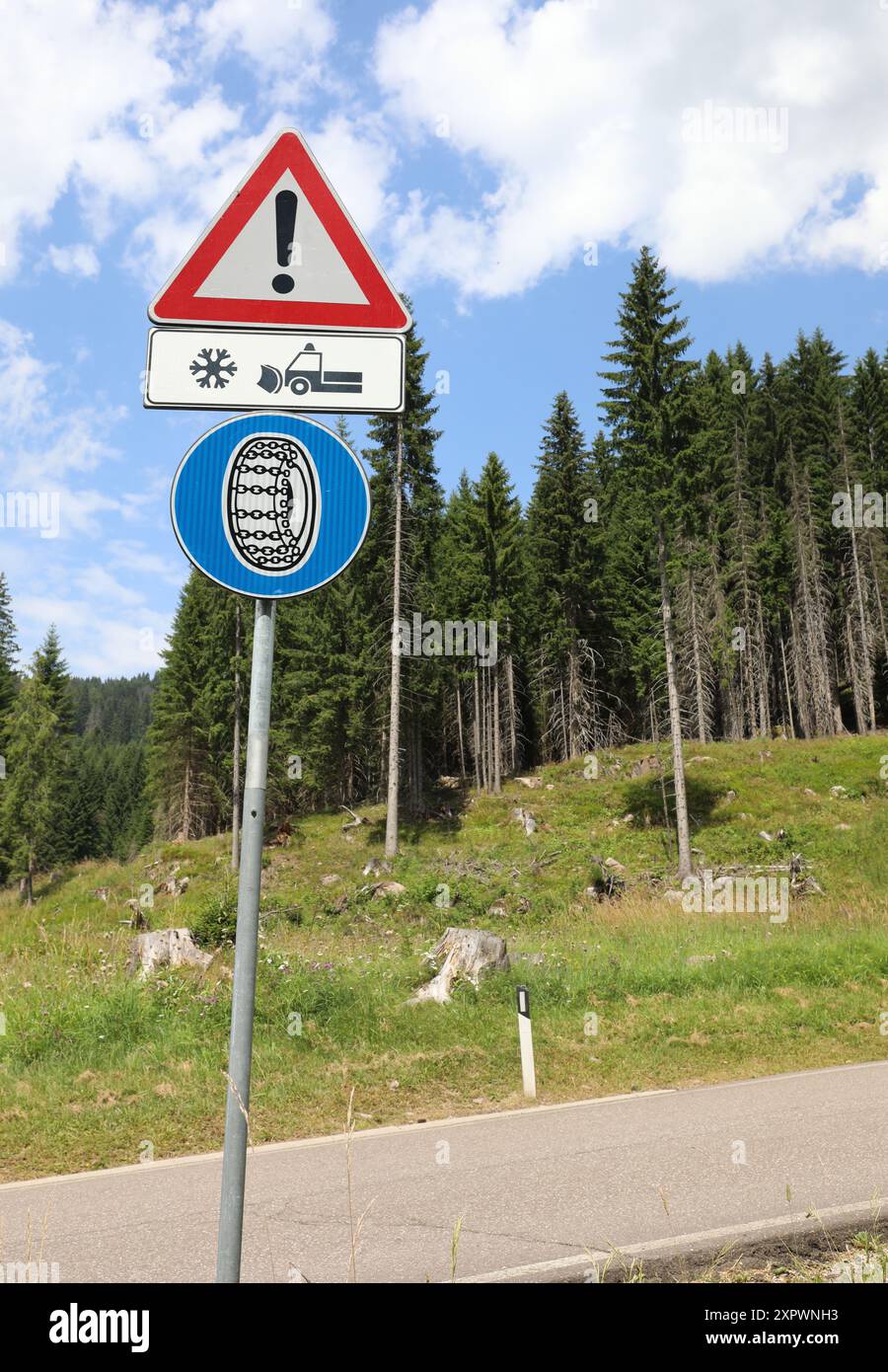 Road sign indicating the mandatory use of snow chains and snowplow in ...