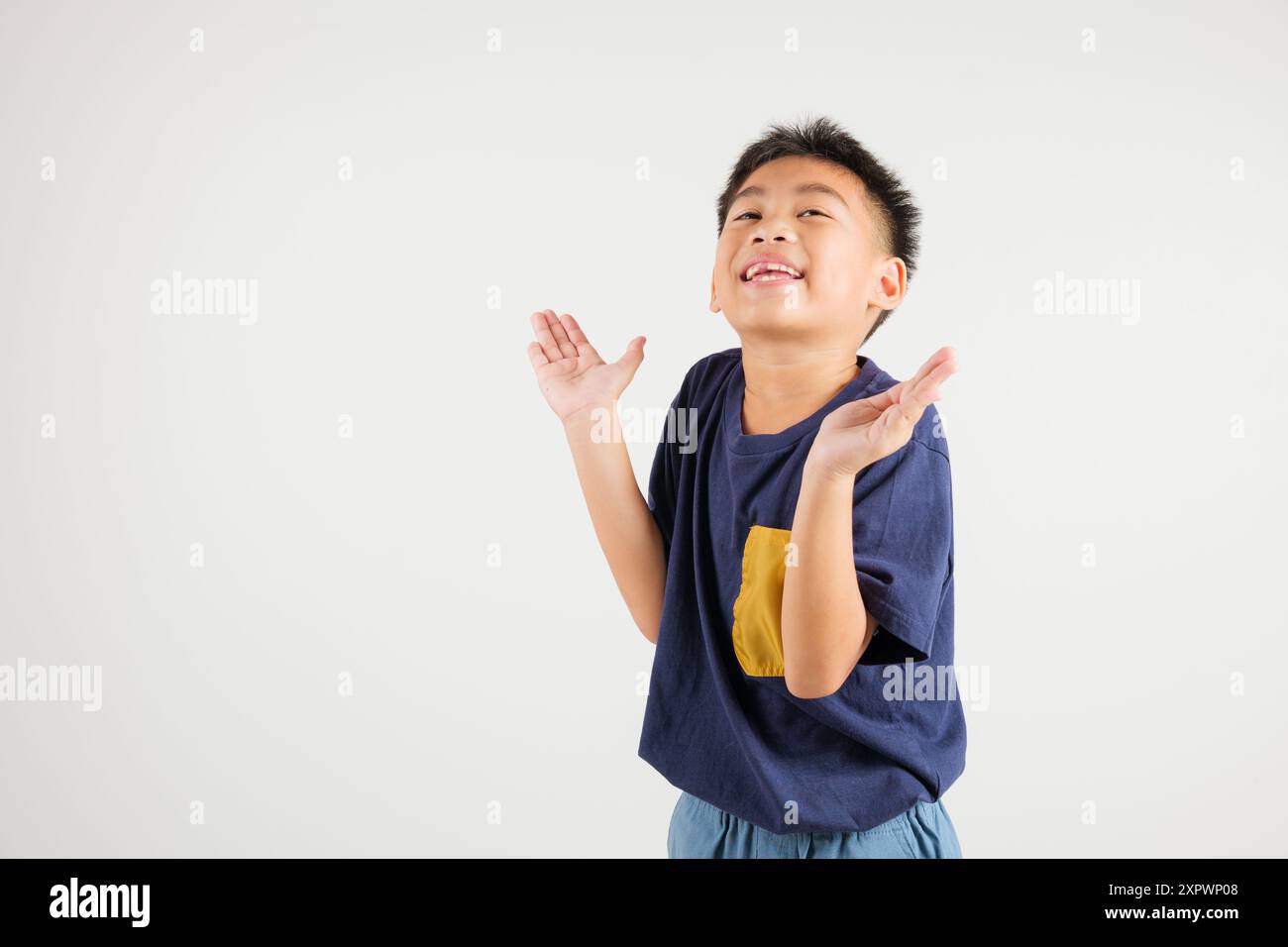 A jubilant kid boy raises her fists in celebration of her success ...