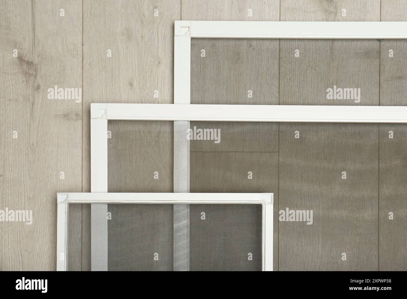 Set of window screens on wooden floor, flat lay Stock Photo - Alamy