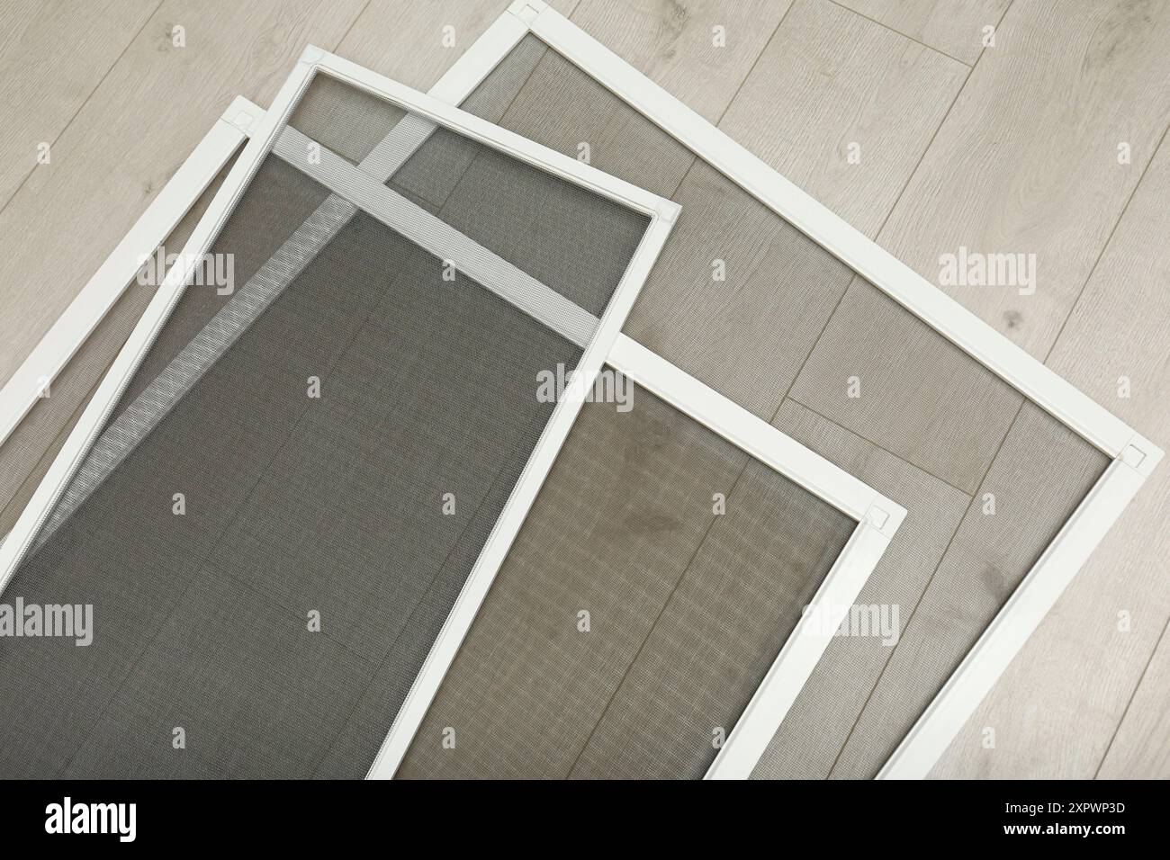 Set of window screens on wooden floor, flat lay Stock Photo - Alamy