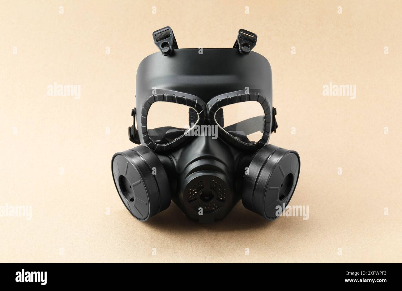 One gas mask on beige background. Safety equipment Stock Photo - Alamy