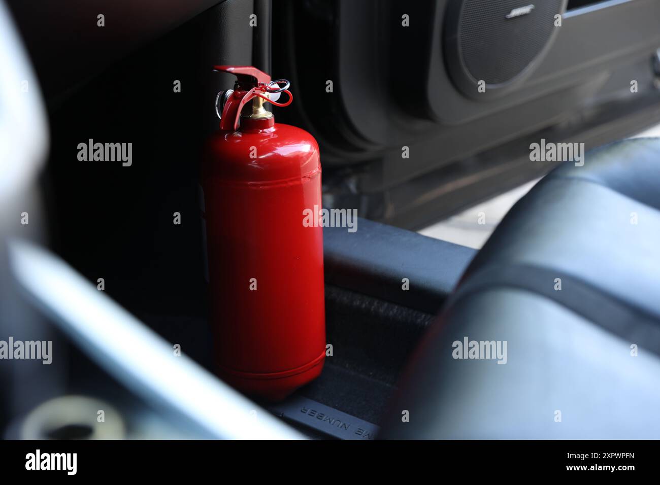 Red fire extinguisher in automobile. Car safety equipment Stock Photo ...
