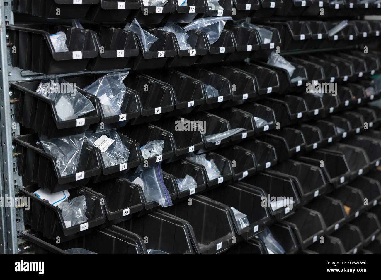 Many plastic boxes for storing car parts in auto store Stock Photo - Alamy