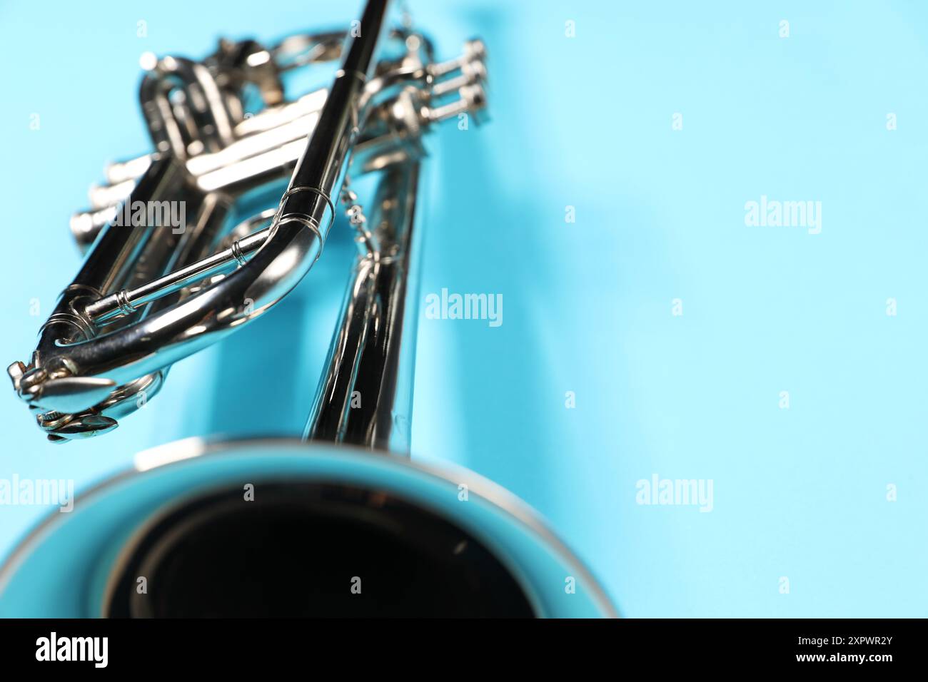 One trumpet on light blue background, closeup. Space for text Stock ...