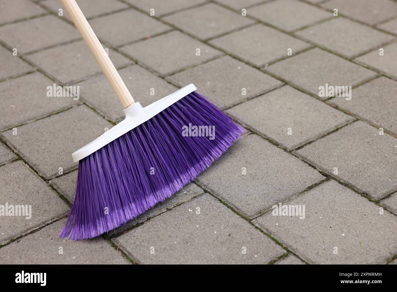 One bright cleaning broom on pavement outdoors Stock Photo - Alamy