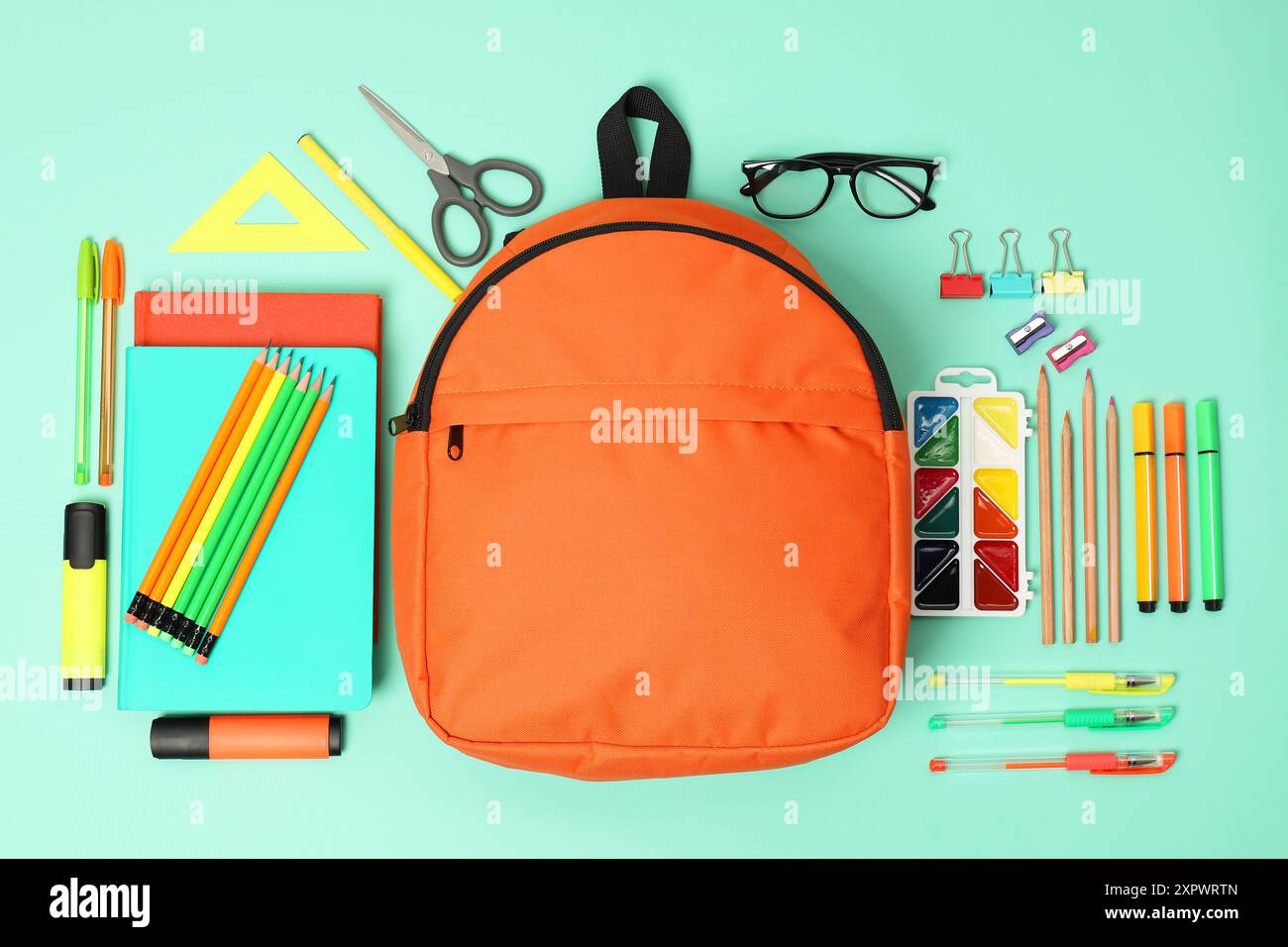 Backpack and different school supplies on turquoise background, flat ...