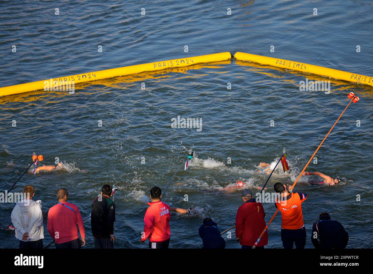 Athletes go through the feeding station during the marathon swimming ...