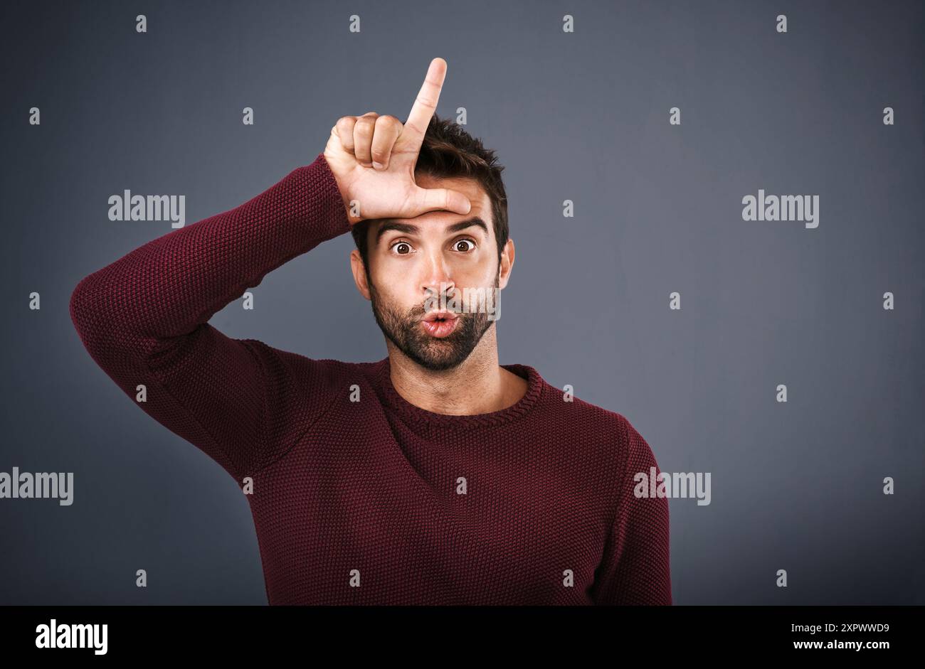 Studio, portrait and man with loser symbol for feedback, opinion and ...