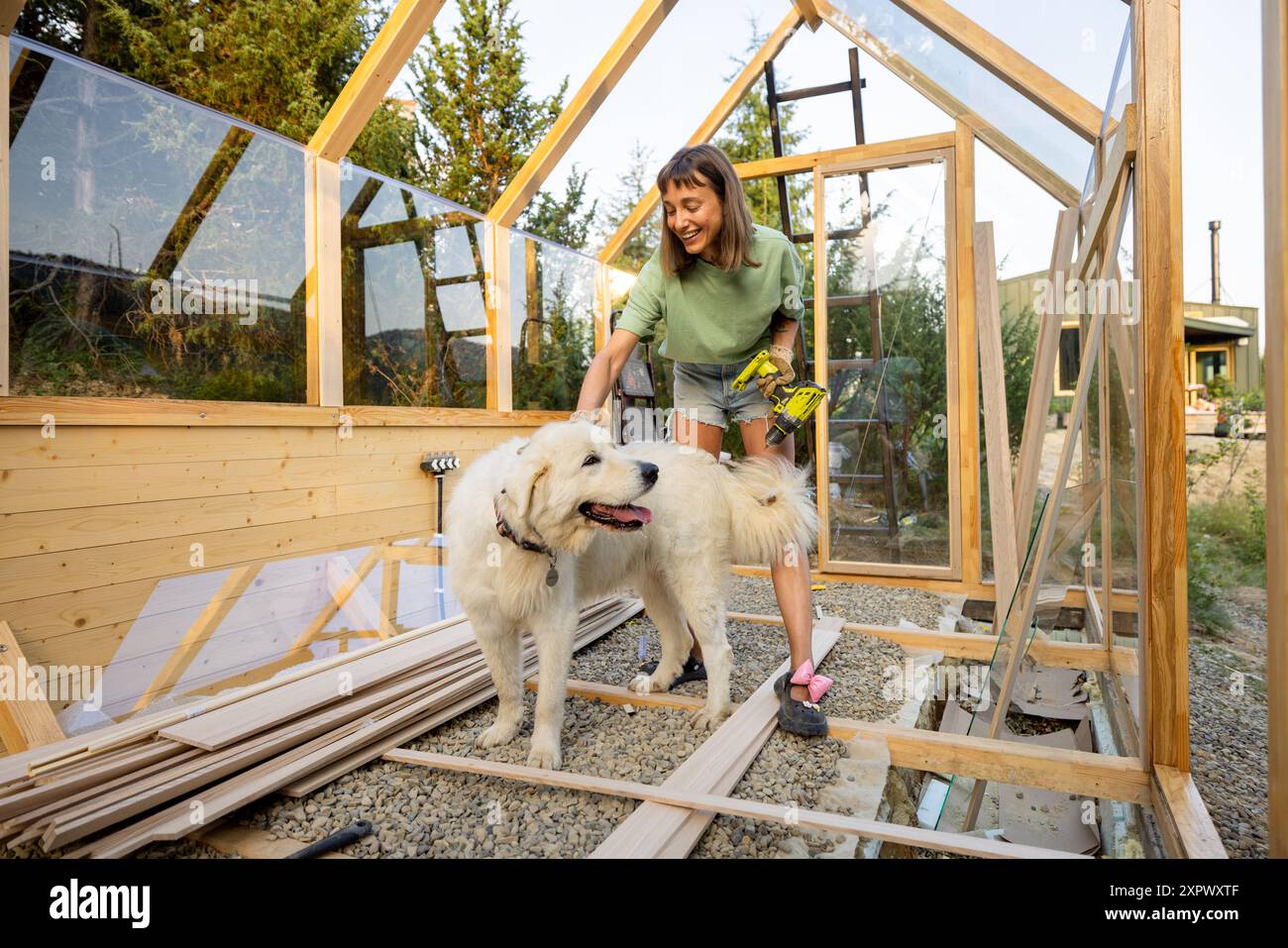 Female Carpenter Playing with Her Dog Stock Photo - Alamy