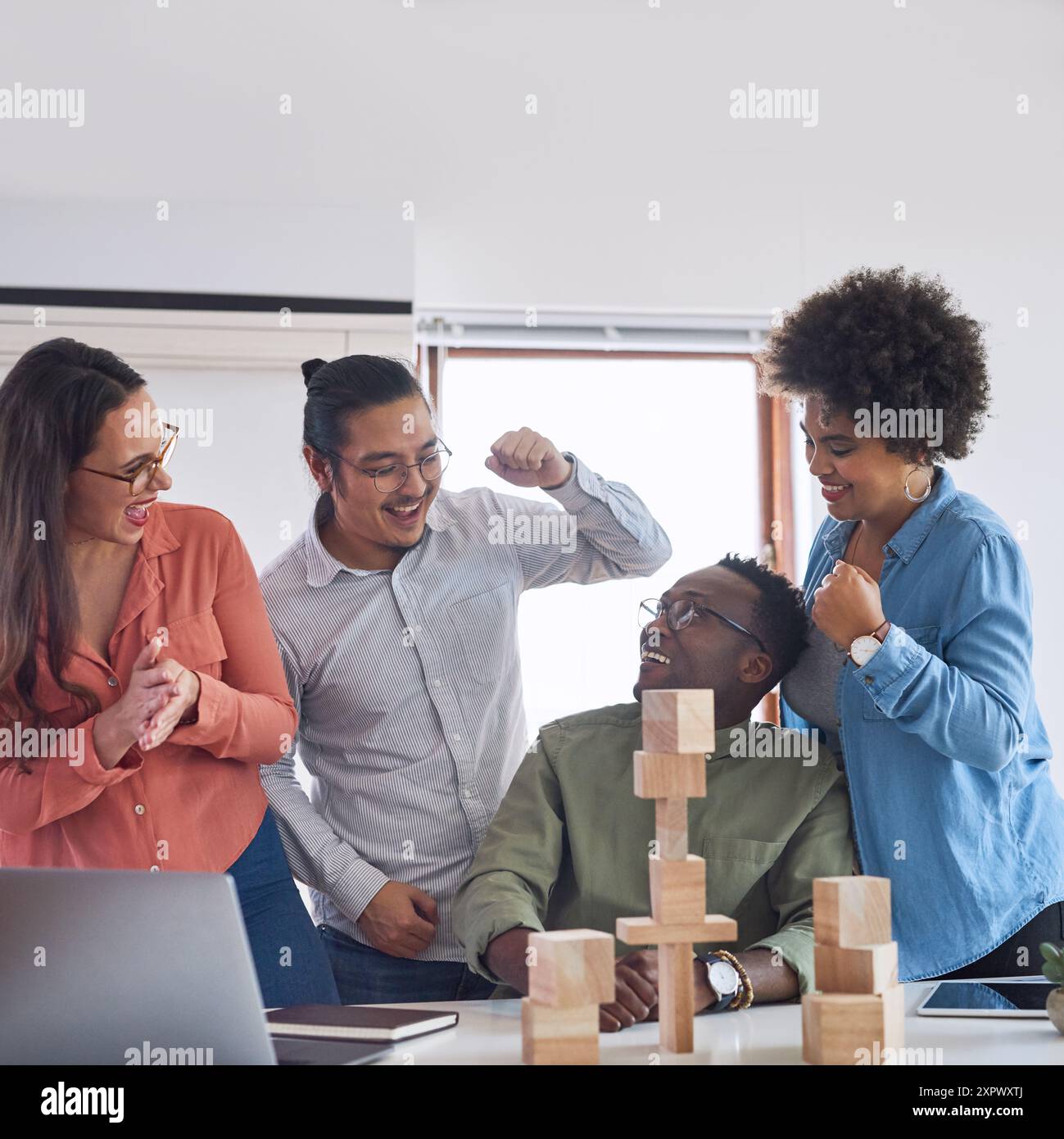 Office, employees and well done on laptop with building blocks for ...