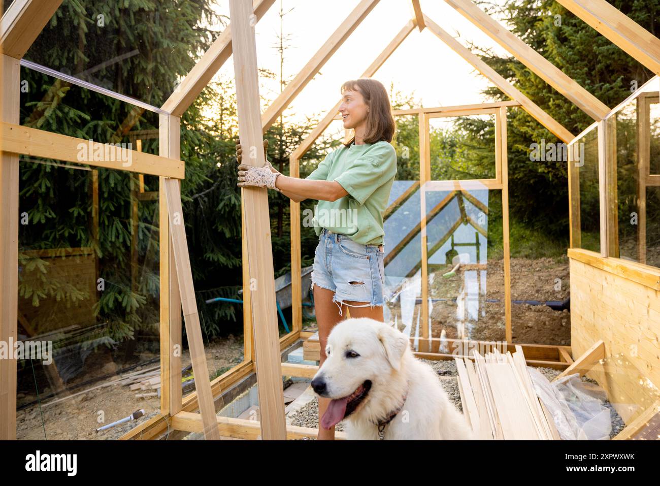 Female Carpenter with Her Dog in Greenhouse Stock Photo - Alamy