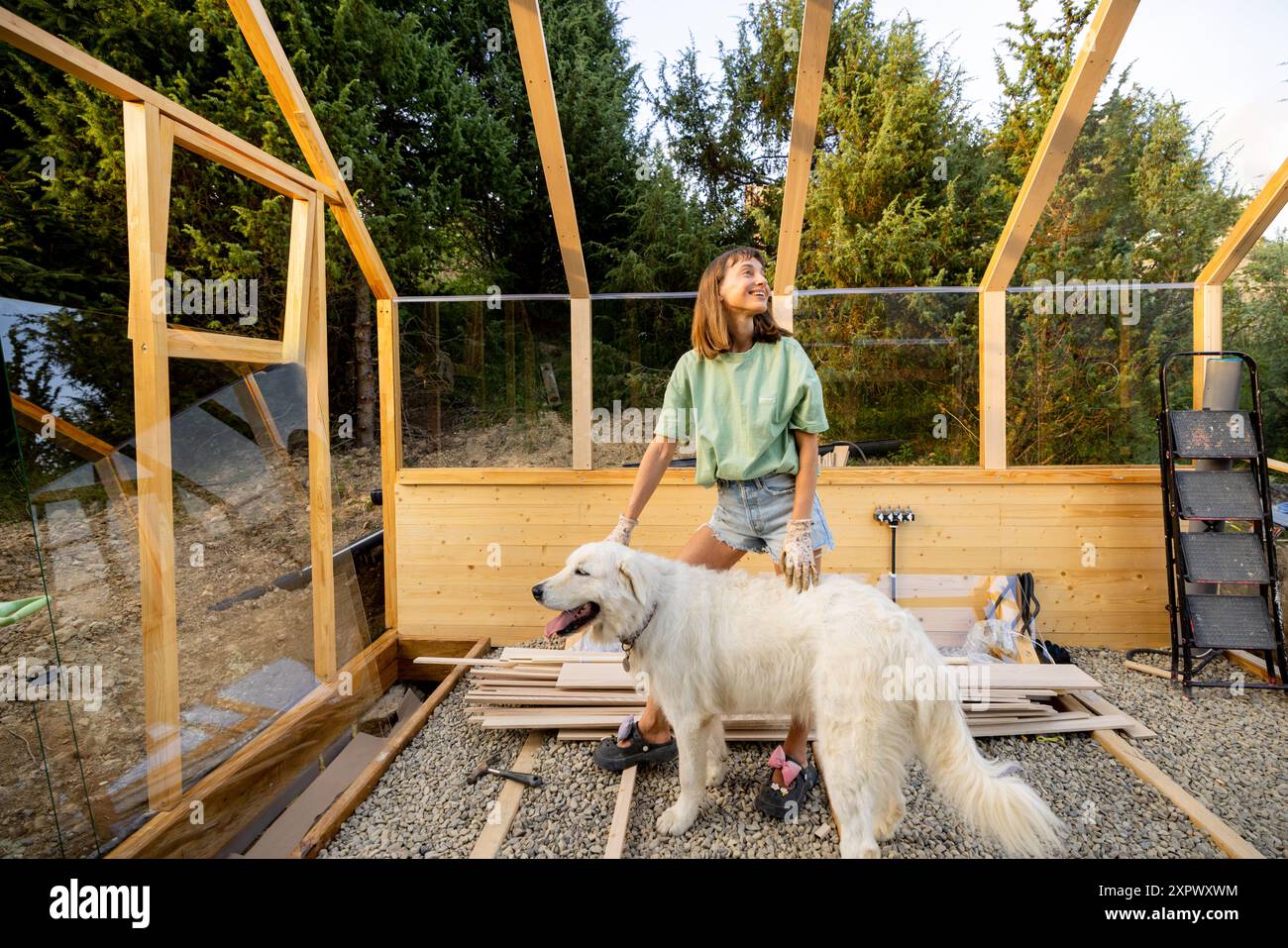 Female Carpenter Playing with Her Dog Stock Photo - Alamy