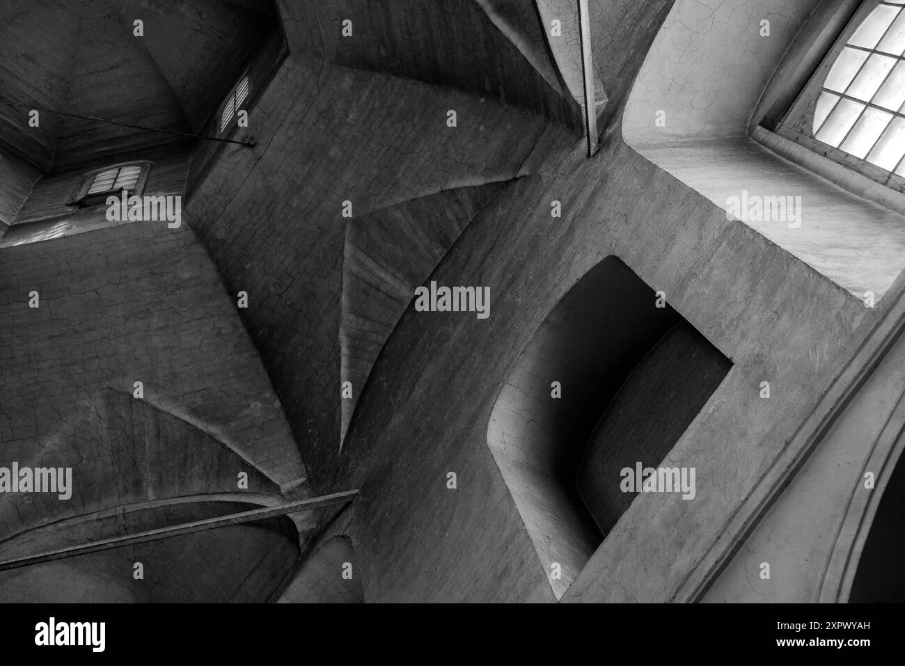 Ancient church interior, cracked gray stone walls and windows are under ...