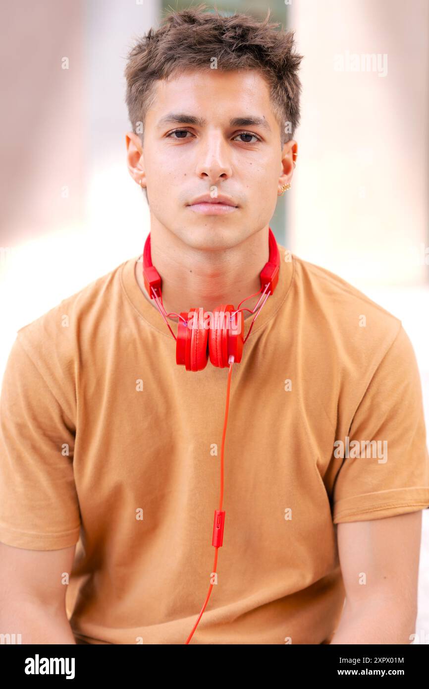 Vertical single portrait young man serious looking at camera outdoors ...