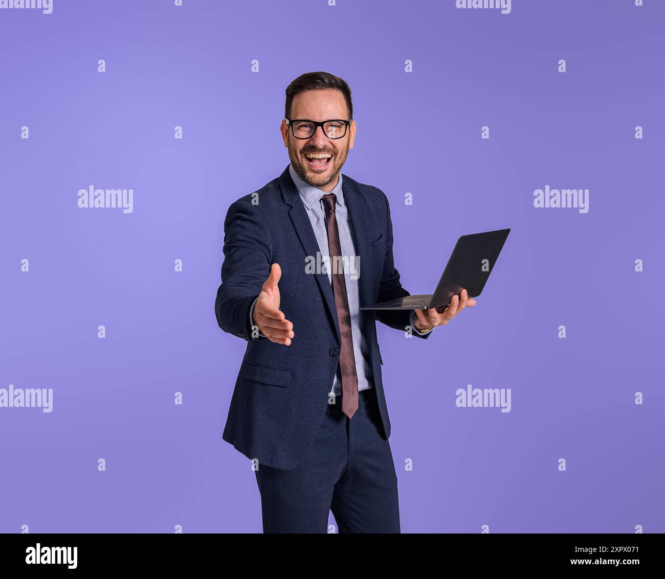 Male cheerful CEO with laptop extending his arm for handshake after ...