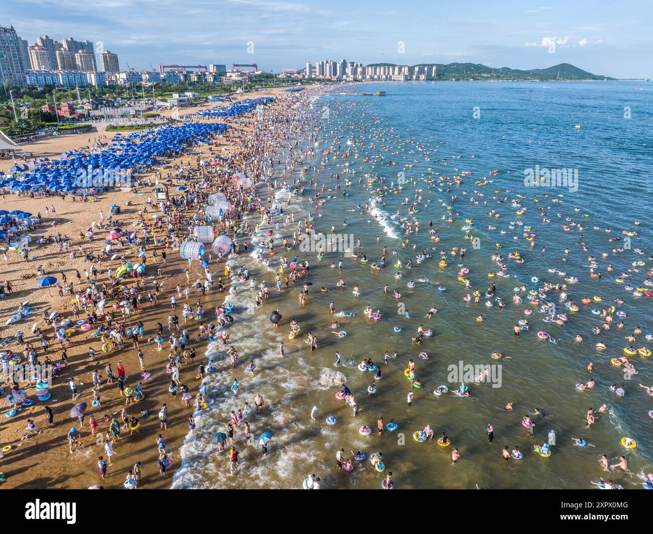 Aerial photo shows tourists enjoying the summer time on the beach in ...