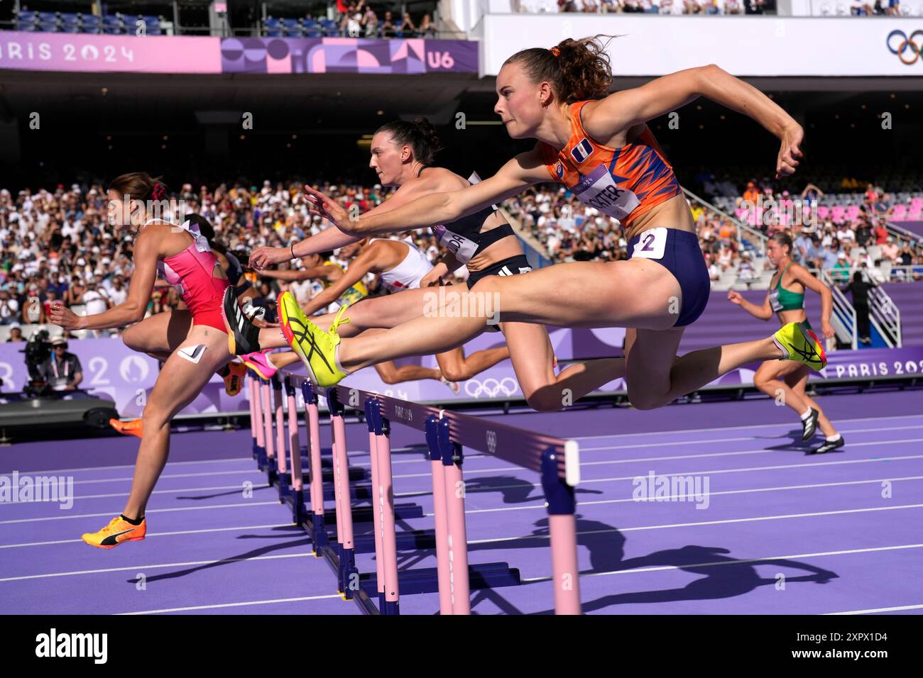 Runners compete during the women's heptathlon 100-meter hurdles at the ...