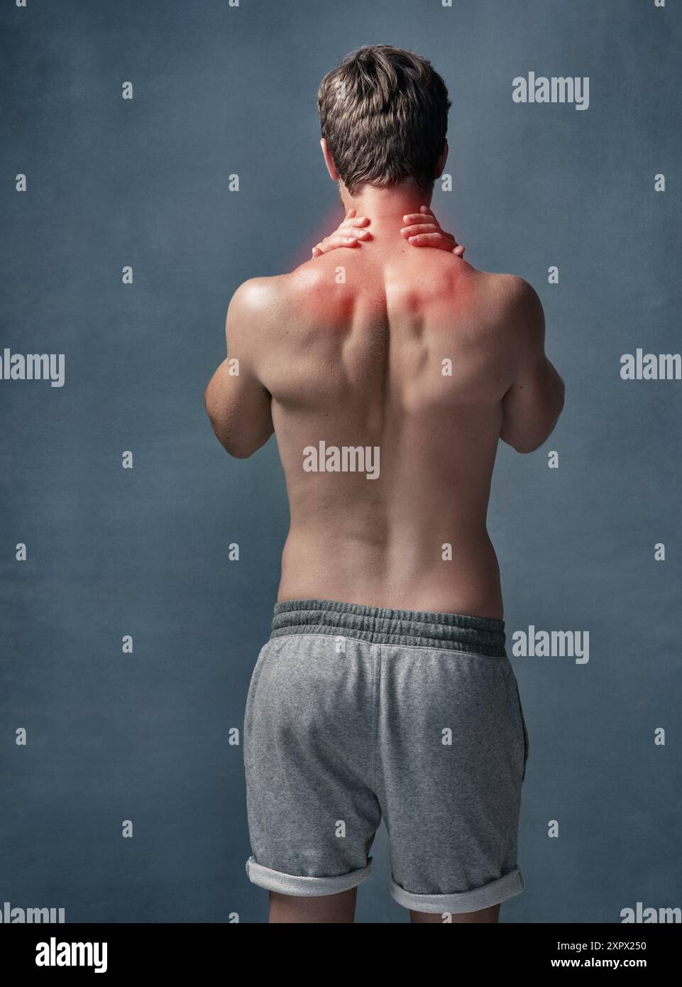 Man, back and neck pain with injury, red glow or inflammation on a blue ...