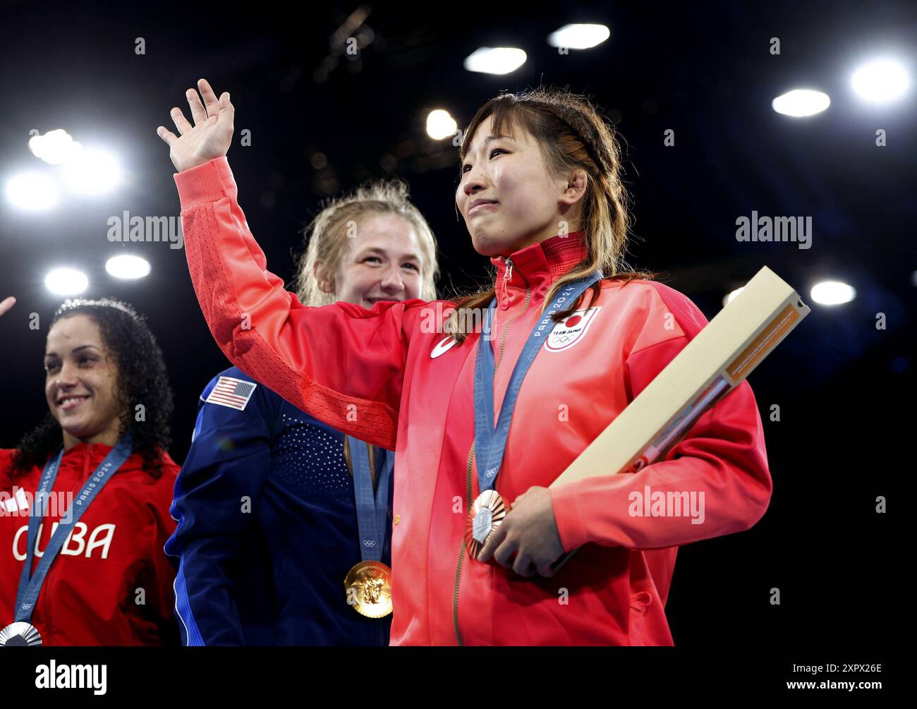 Yui Susaki (R) of Japan waves to the crowd at the medal ceremony after ...