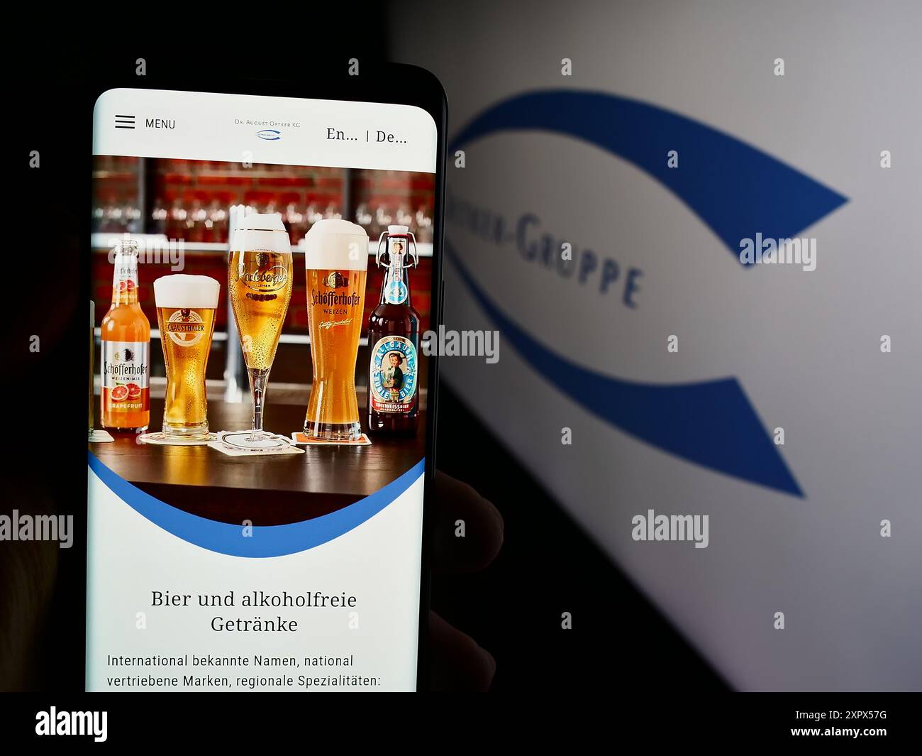 Person holding smartphone with webpage of German food processing ...