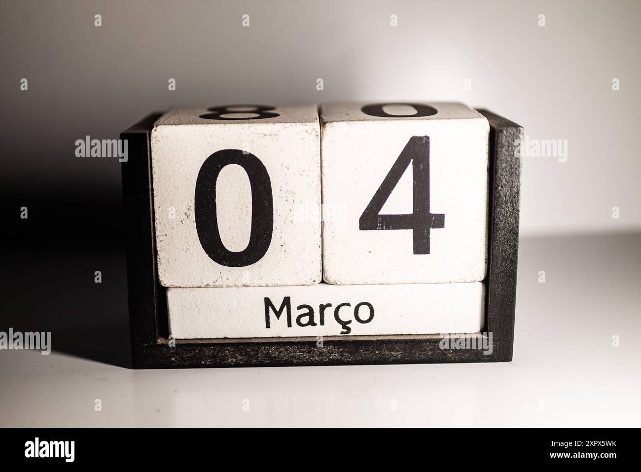 A close-up of a perpetual calendar showing March 4th with a white ...