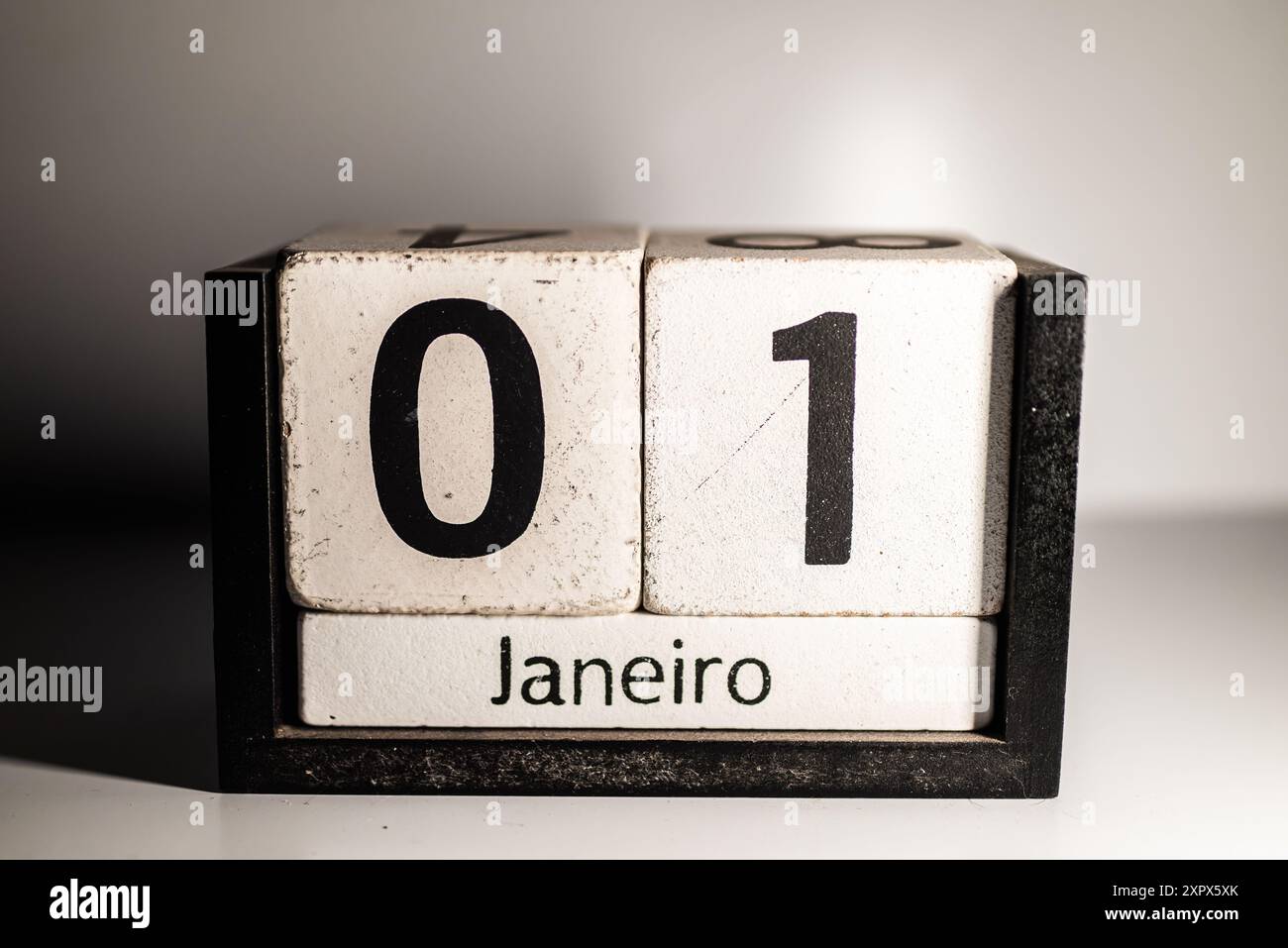 A close-up of a wooden block calendar showing January 1st with a ...